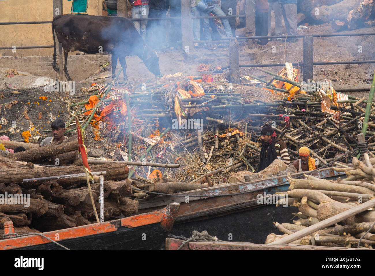 India, Uttar Pradesh, Varanasi. Cremation pyre along the Ganges River ...