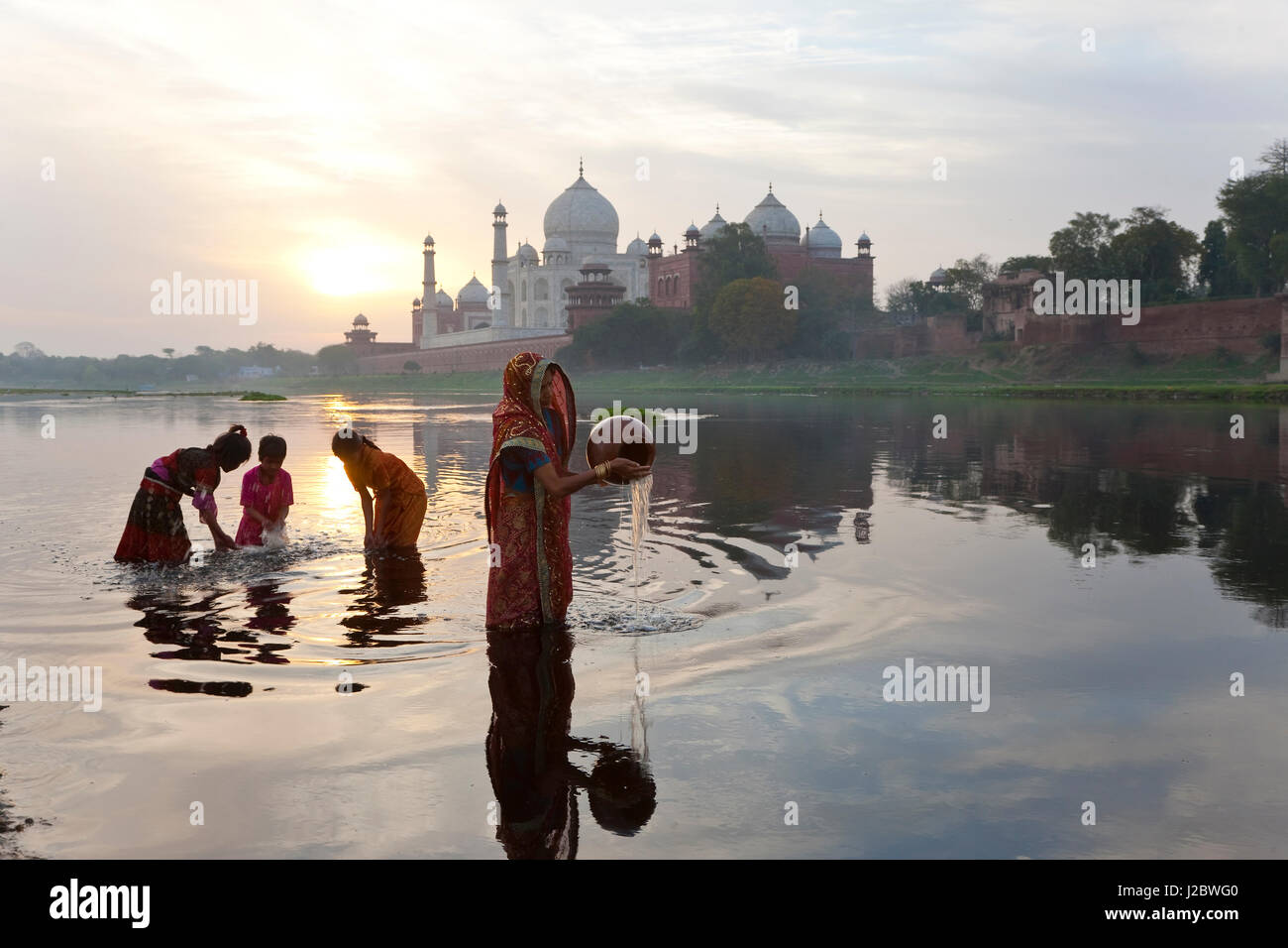 Taj Mahal and collecting water on the banks of the River Yamuna, Agra ...