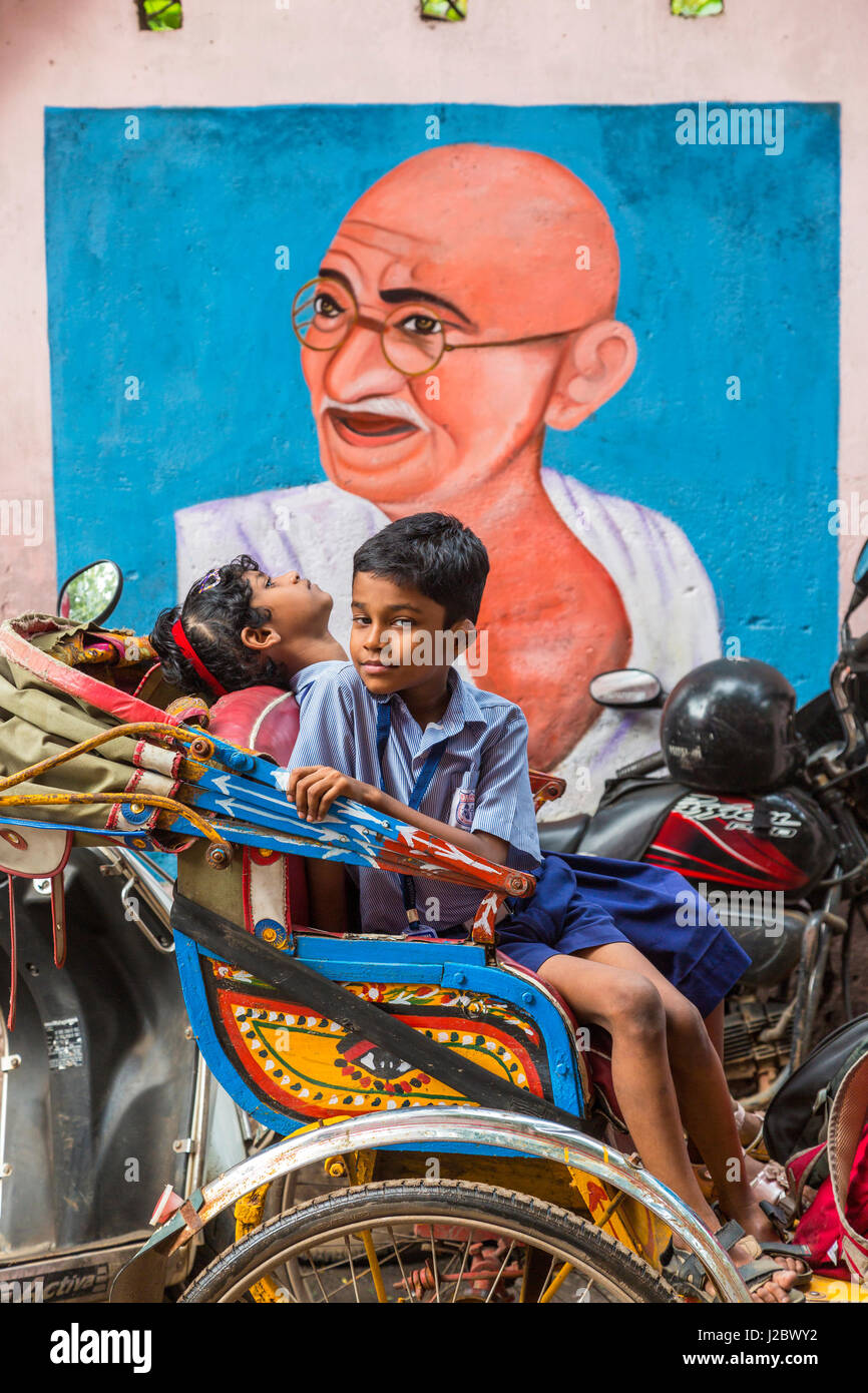 School children in cycle-rickshaw, with Gandhi mural, Chennai, (Madras ...