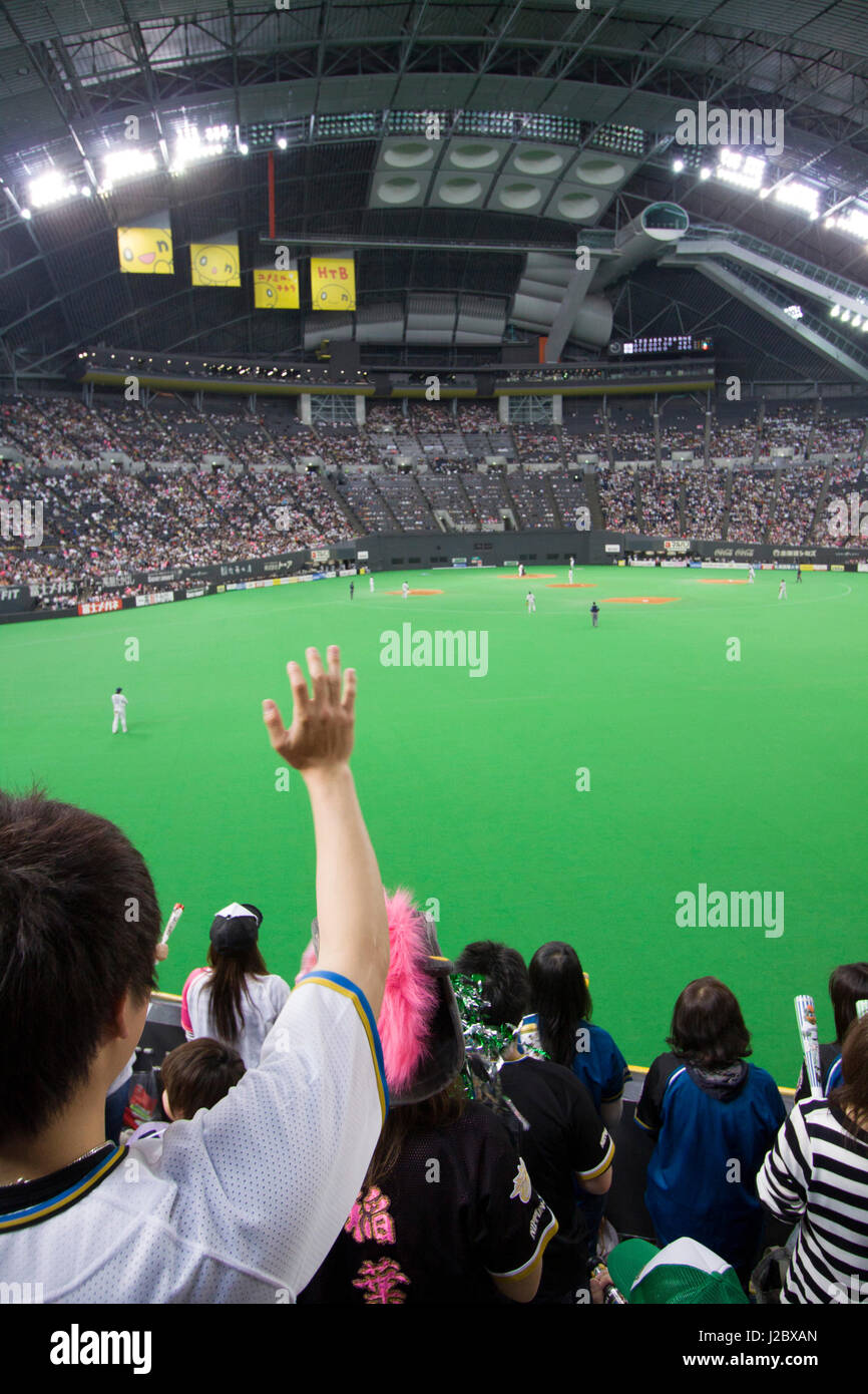 A giant crowd of people at the Sapporo Dome in Sapporo, Hokkaido gather ...