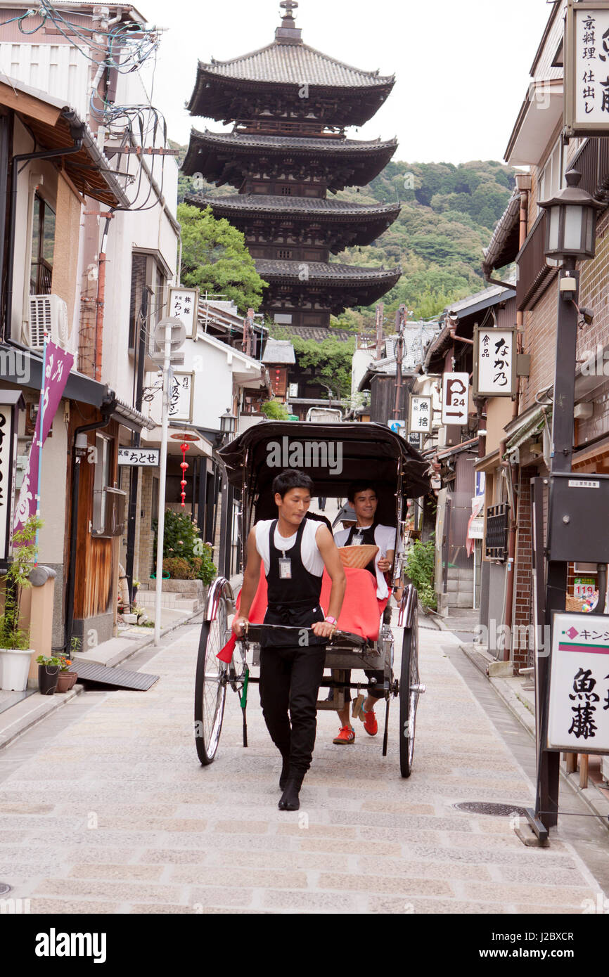 A rickshaw puller in training pulls his bosses through the streets of ...