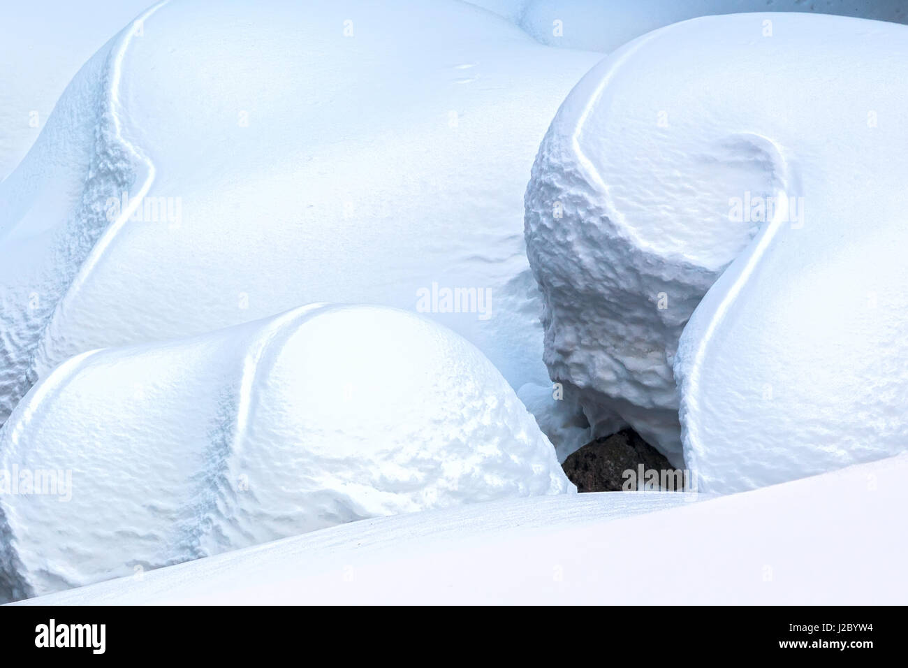 Oval snow forms by the river Stock Photo - Alamy