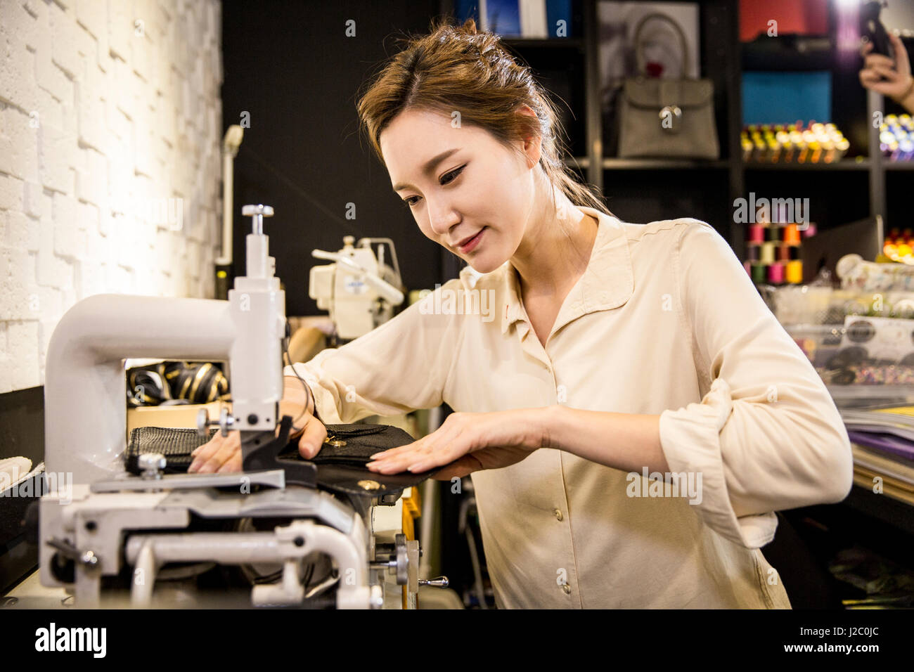 Female designer making a bag Stock Photo - Alamy
