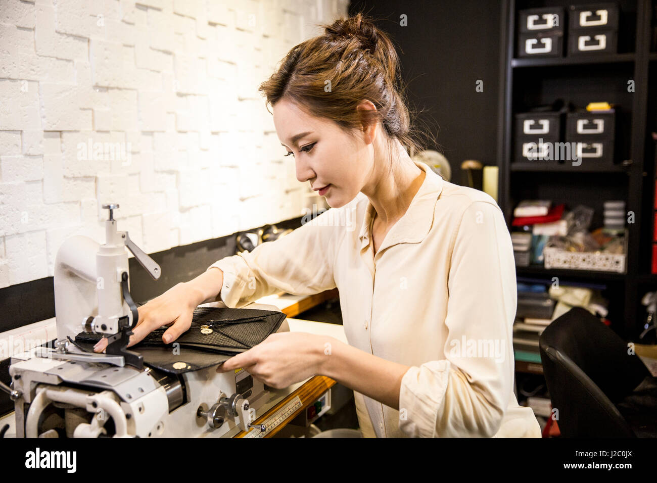 Female designer making a bag Stock Photo - Alamy