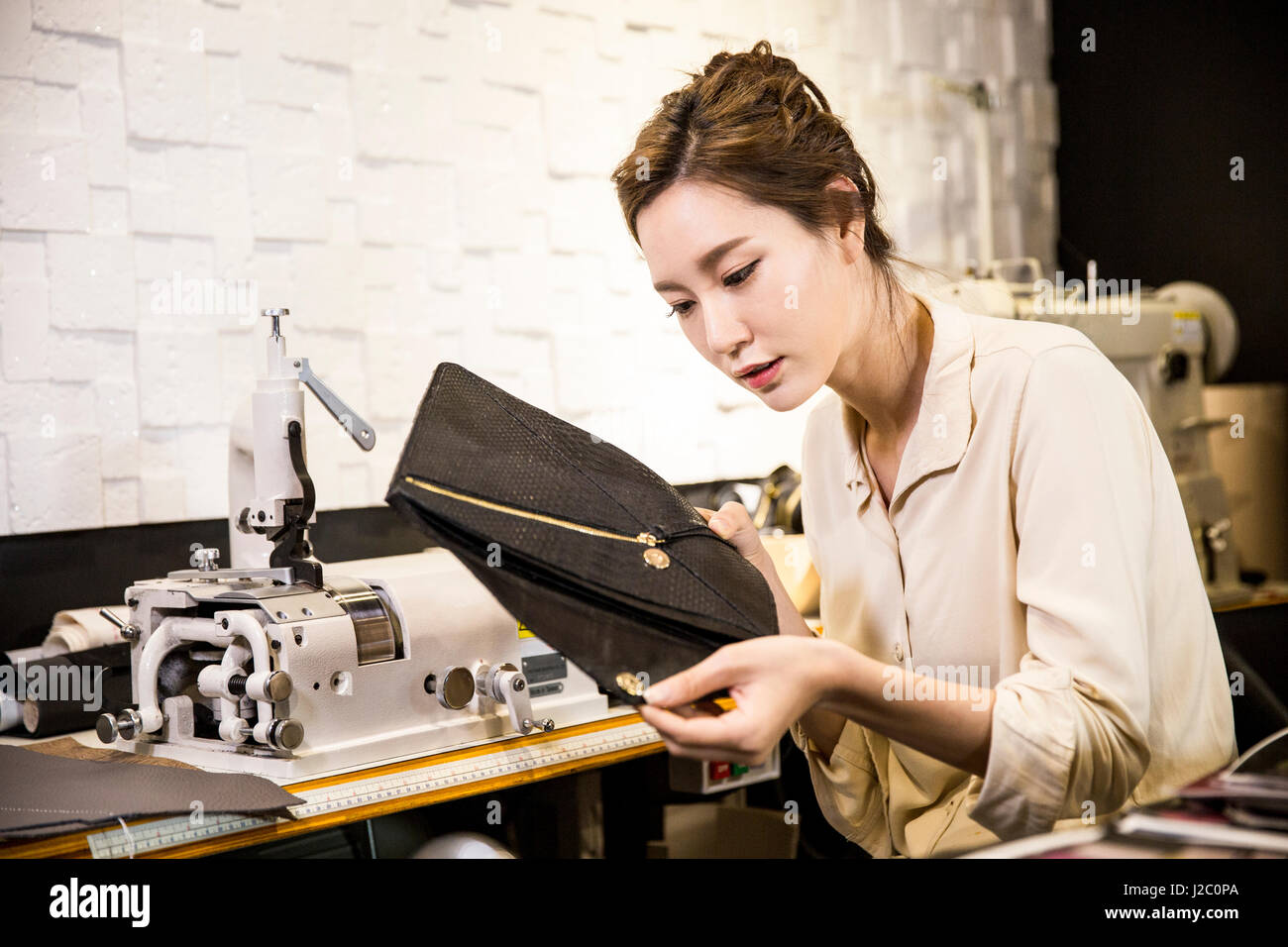 Young female designer making a bag Stock Photo - Alamy