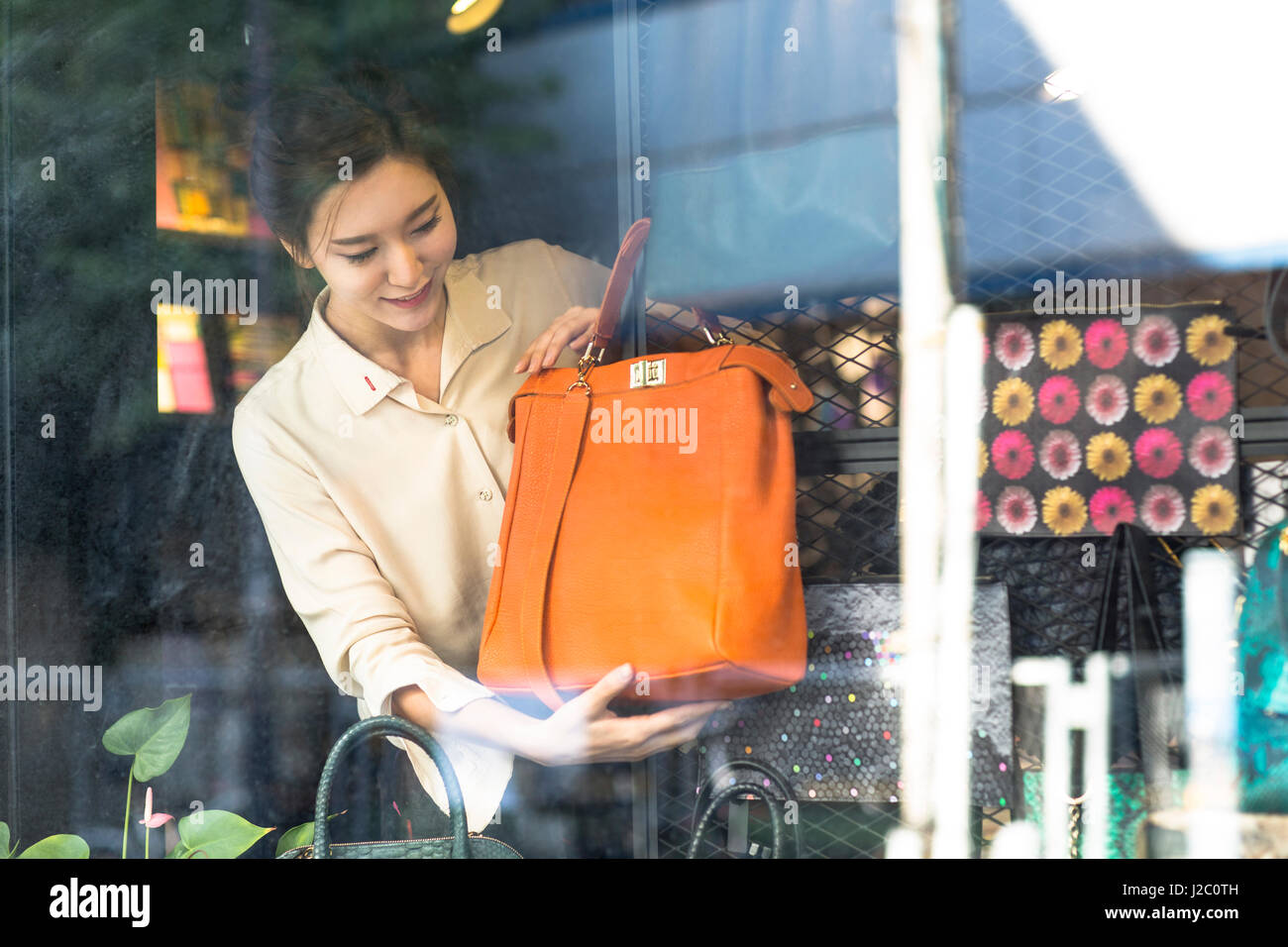 Young smiling female shopkeeper Stock Photo - Alamy