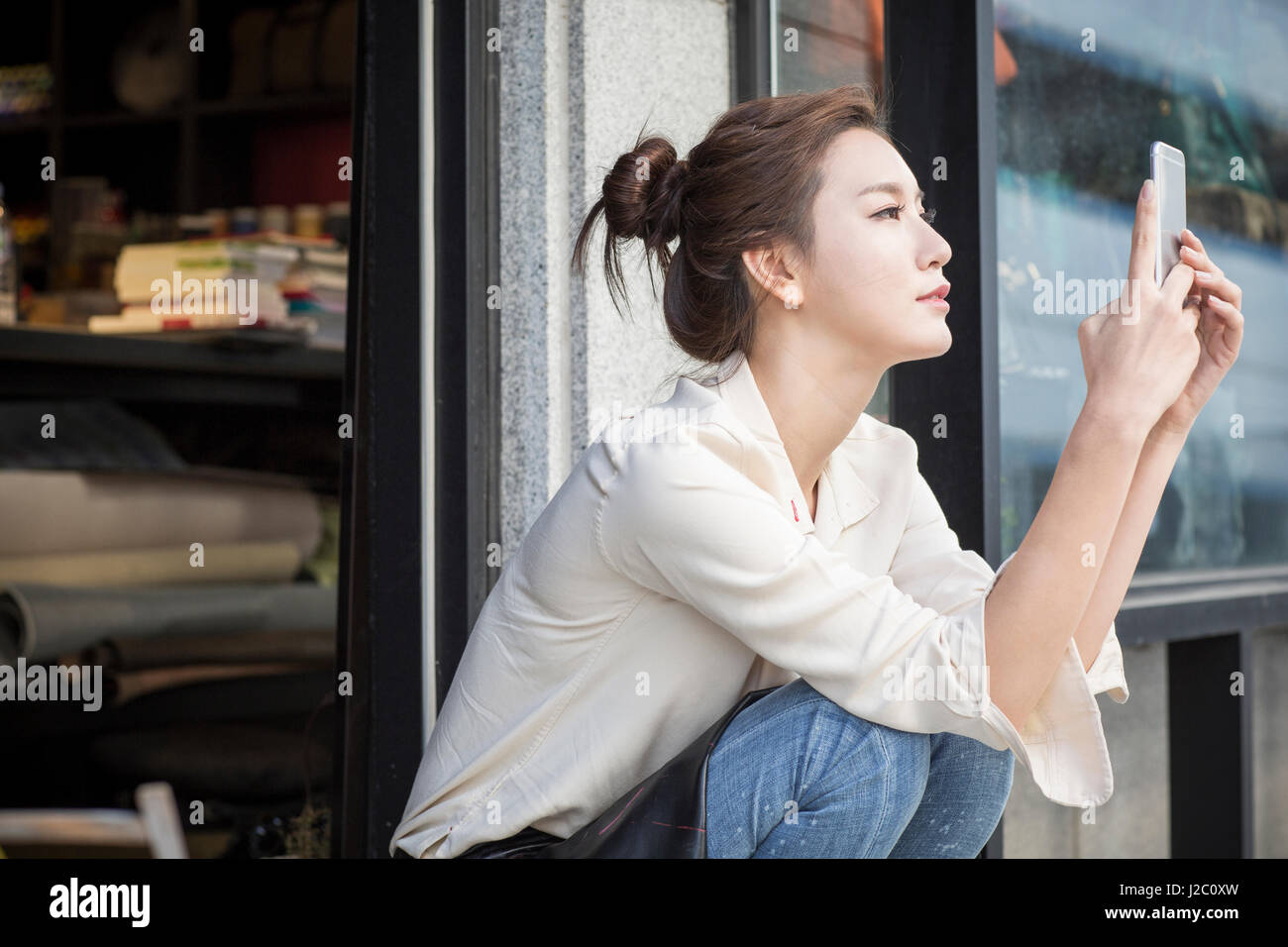 Young female shopkeeper Stock Photo - Alamy