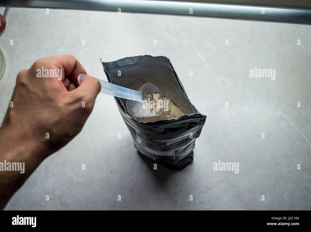 Male Hand Scooping Whey Protein Powder from a Bag Stock Photo - Alamy