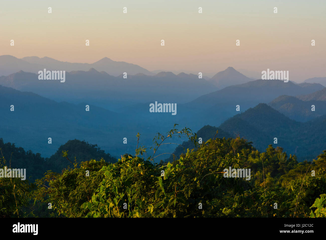 Myanmar. Shan State. Near Kalaw. Sunset over the ridges of haze-filled ...