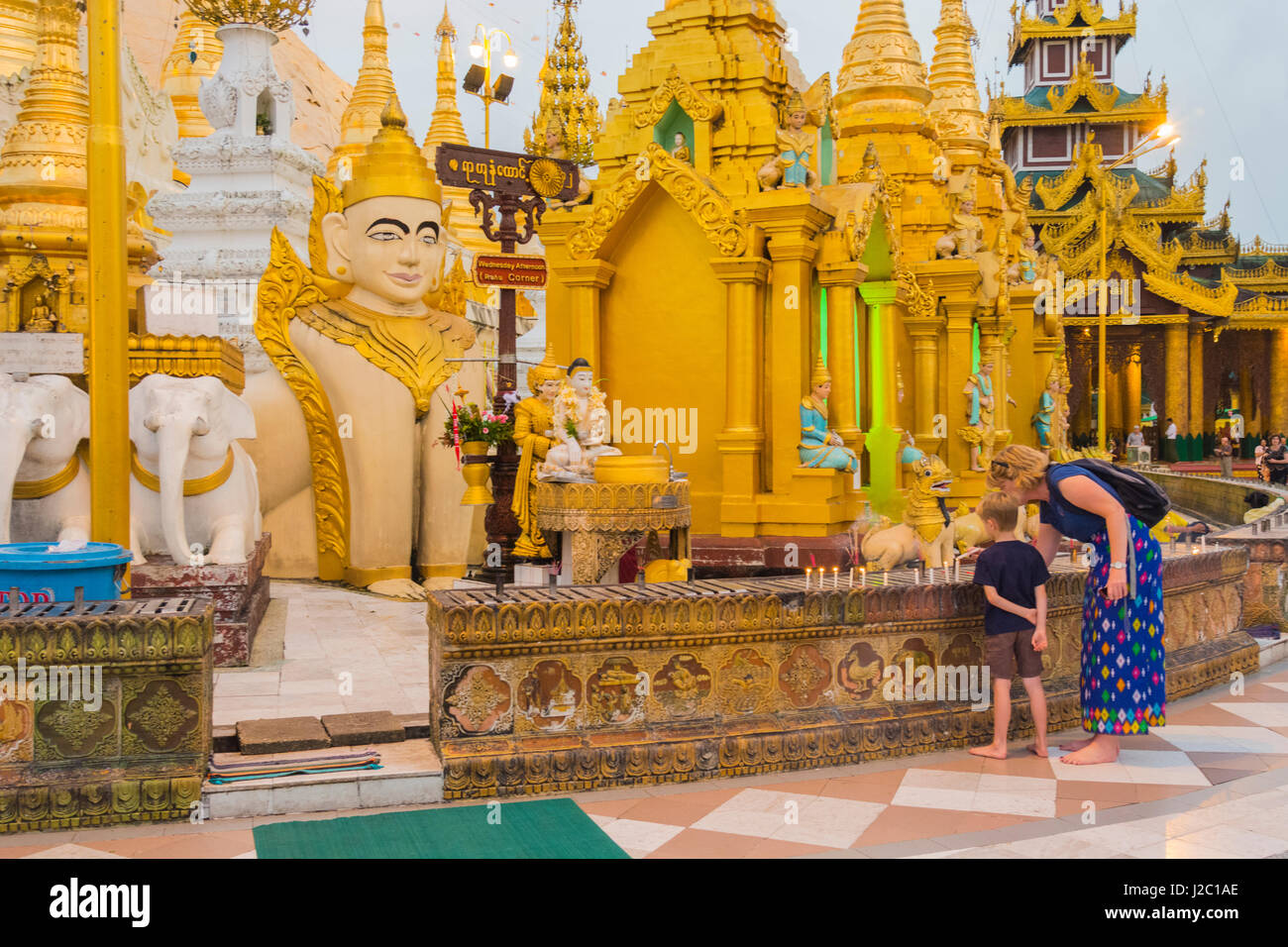 Myanmar. Yangon. Shwedagon Pagoda. Tourists light candles Stock Photo - Alamy