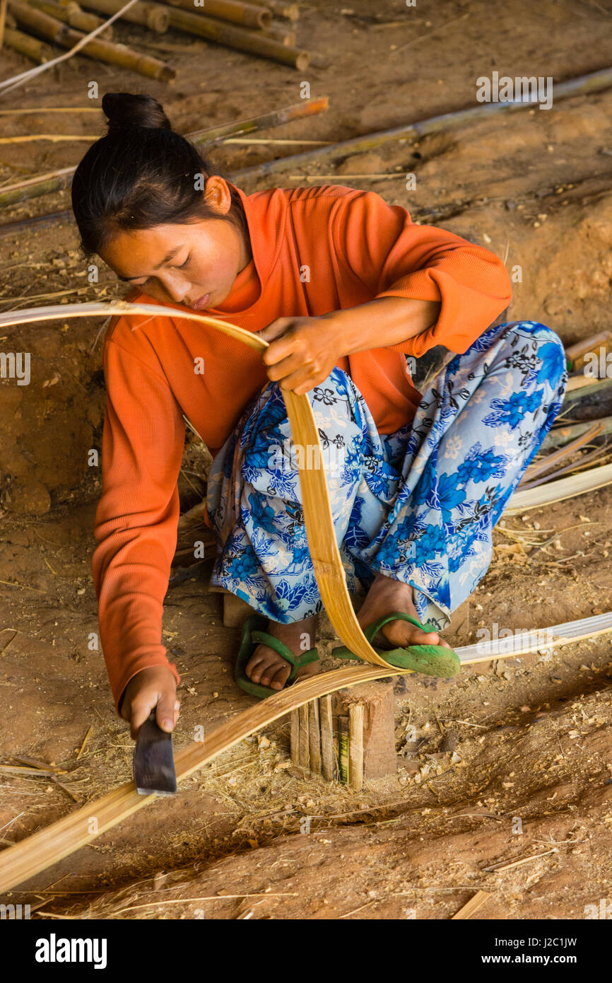 Myanmar. Shan State. Kalaw. Woman splits bamboo to make bamboo mats ...