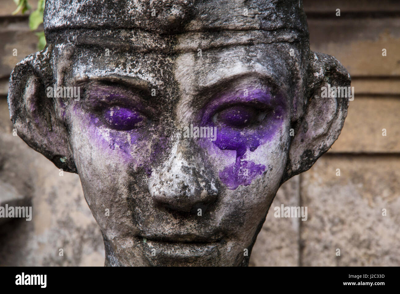 Indonesia, Bali. Purple dye on statue eyes Stock Photo - Alamy