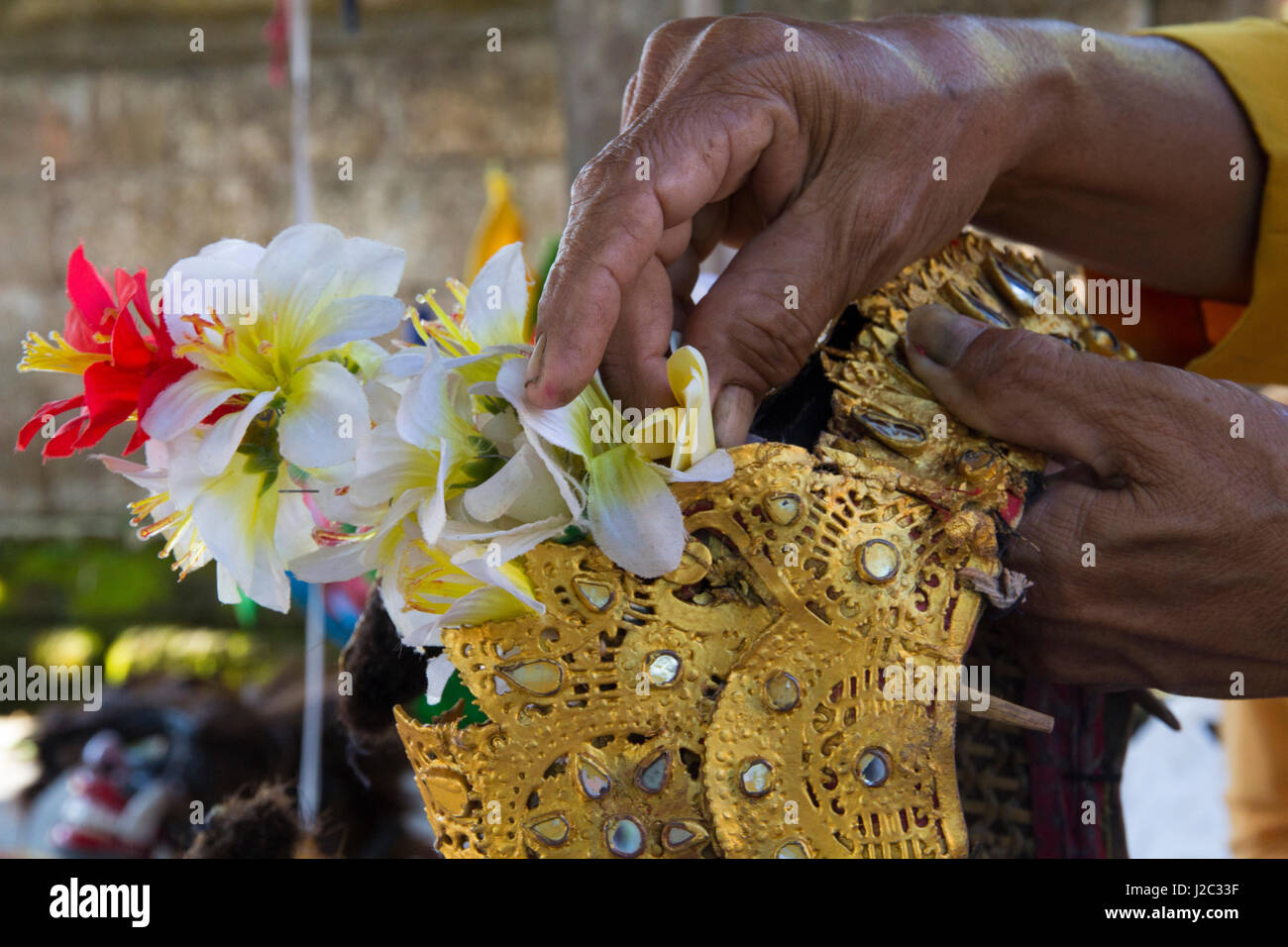 Indonesia, Bali. Indonesian decorative crown being adorned with native ...