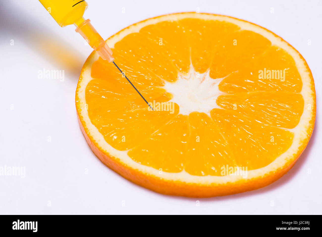Science experiment with orange and syringe isolated on white Stock ...