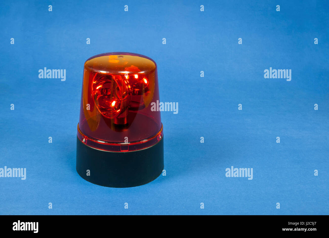 Red emergency beacon with rotating encapsulated mirrors for visual and ...