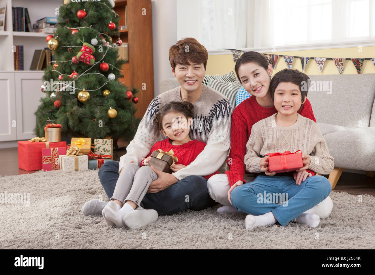 Harmonious family with Christmas tree Stock Photo - Alamy