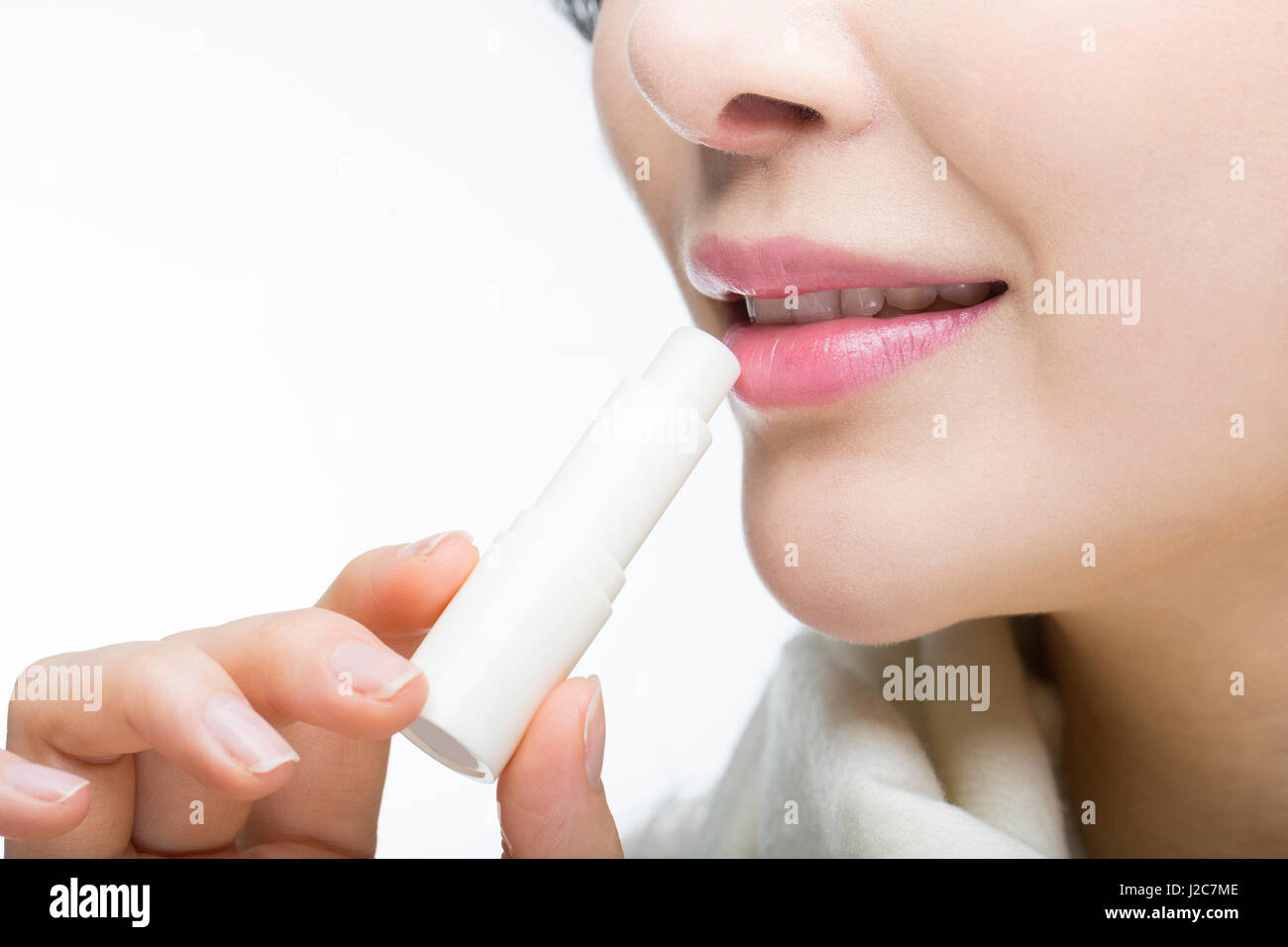 Young woman with lip balm Stock Photo - Alamy