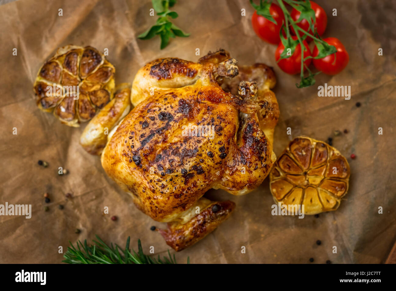 Roasted whole chicken on backing paper Stock Photo - Alamy