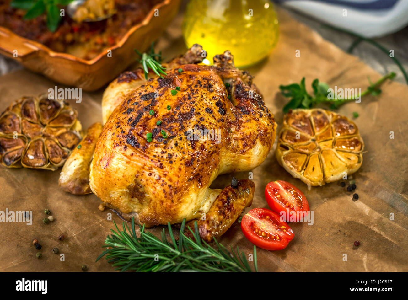 Roasted whole chicken on backing paper Stock Photo - Alamy