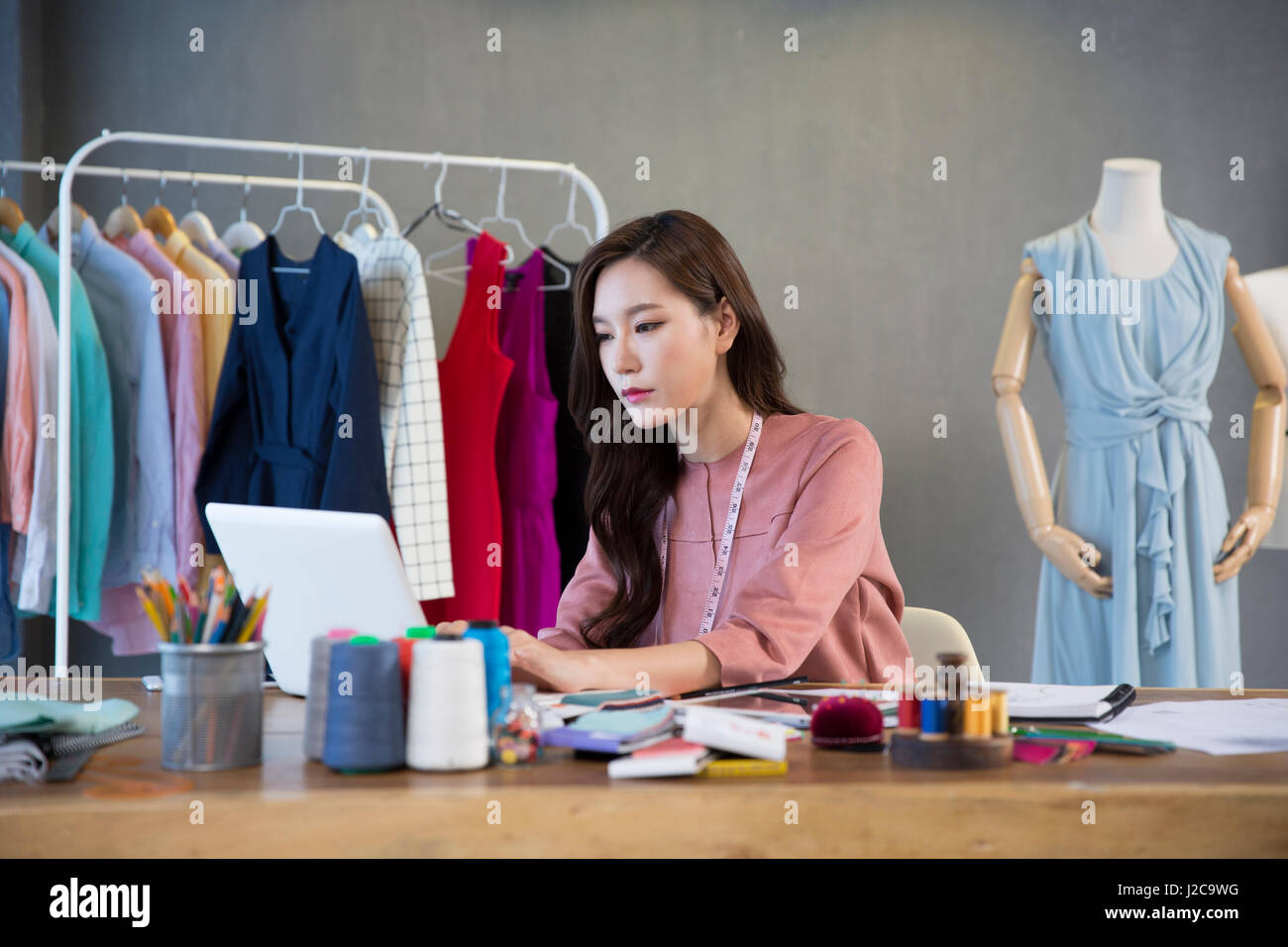 Female fashion designer working Stock Photo - Alamy