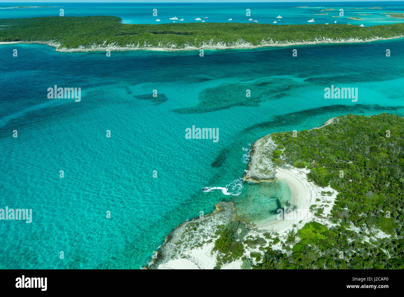 Aerial photo looking down at the airplane's shadow a jet ski and clear ...
