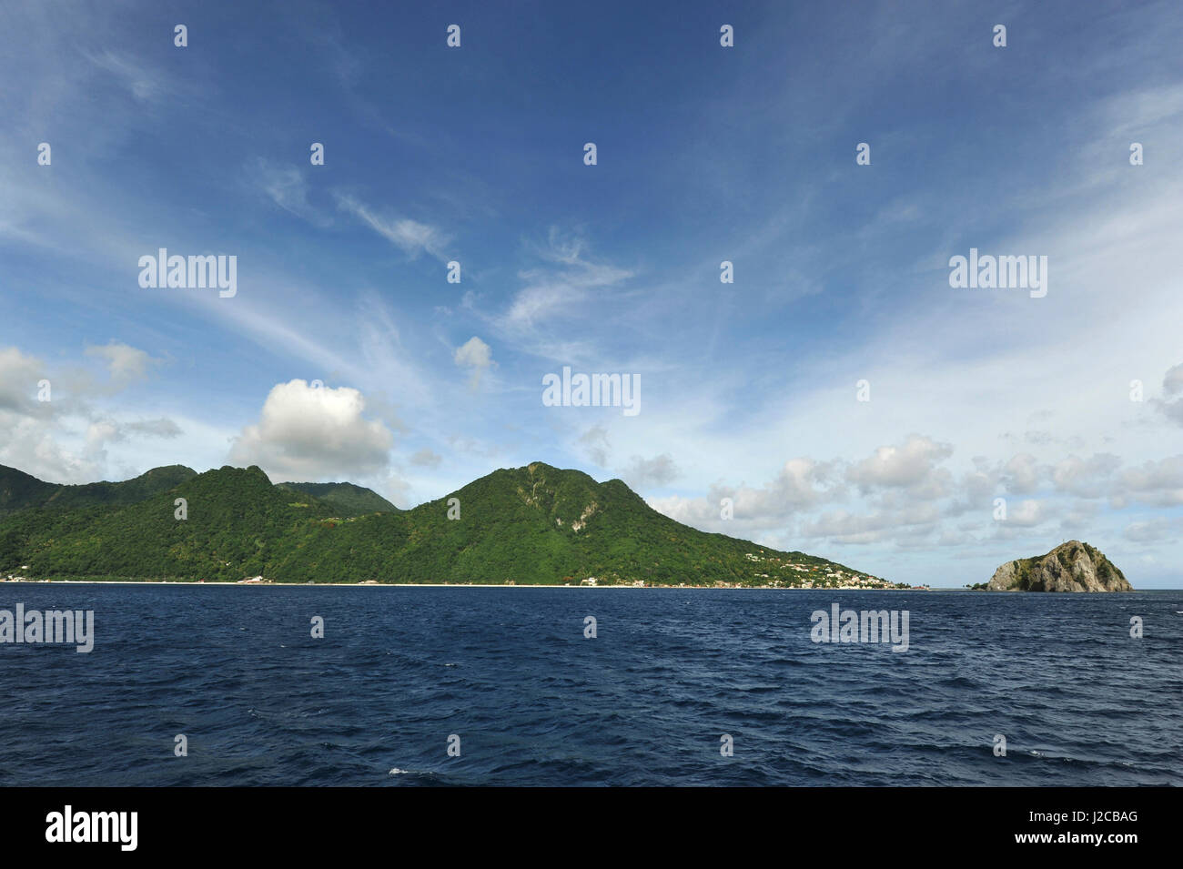 Dominica, Roseau, rock which southern tip of the island and lush green ...