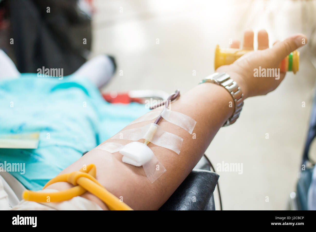 Donate blood using a needle in the arm Stock Photo - Alamy