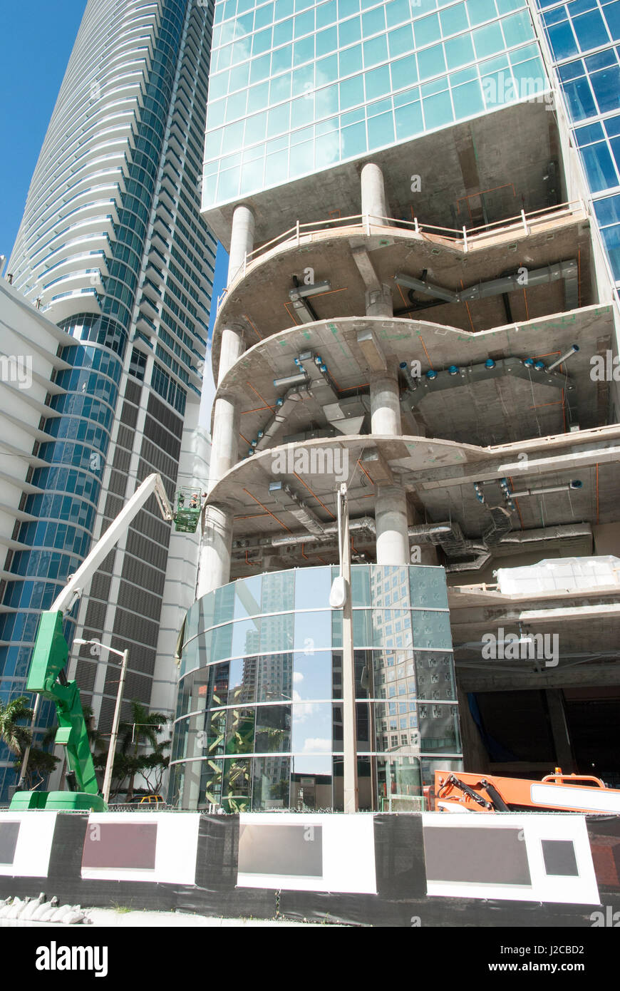 The modern skyscraper getting covered in glass, the construction site ...
