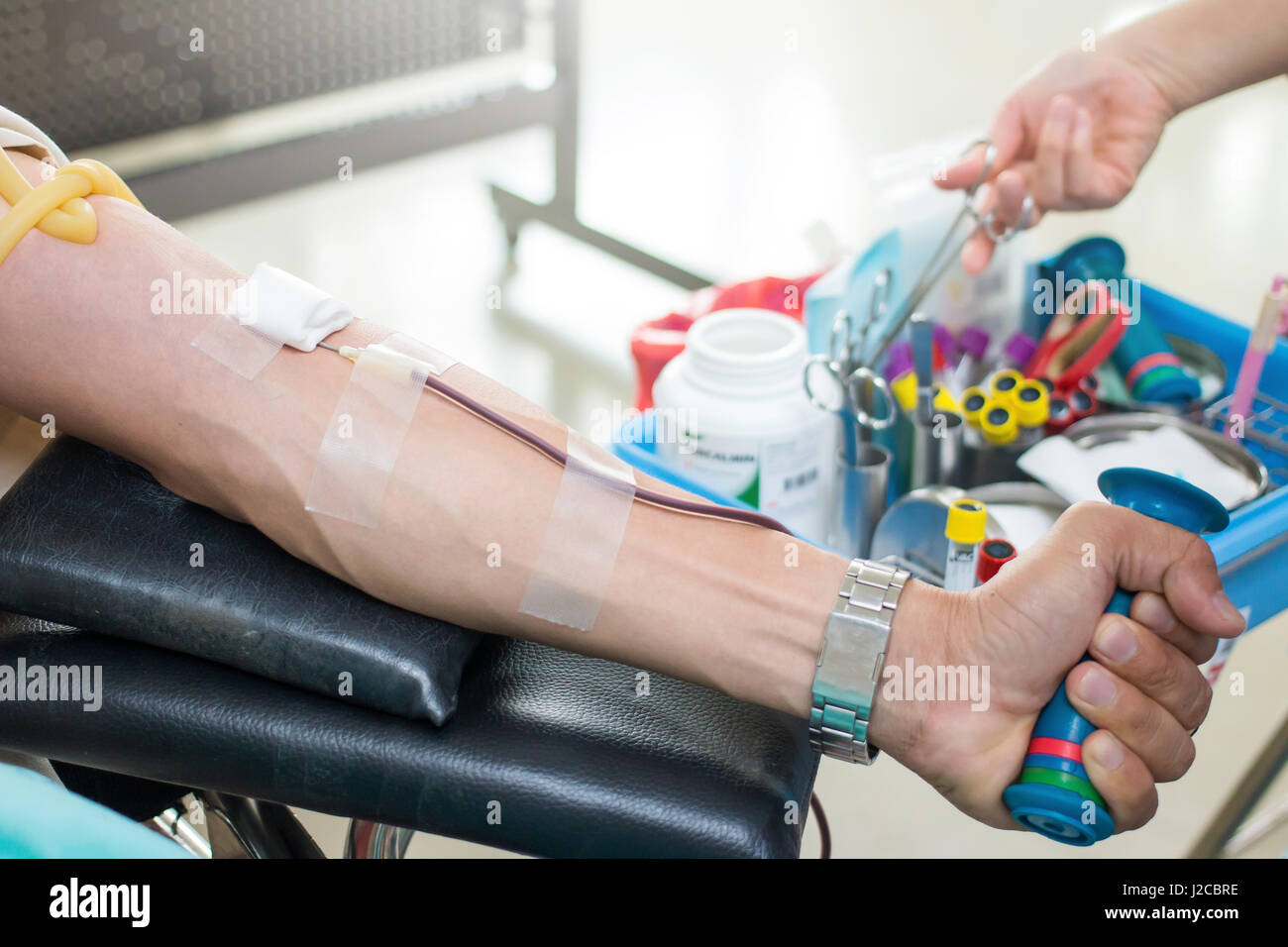 Donate blood using a needle in the arm Stock Photo - Alamy