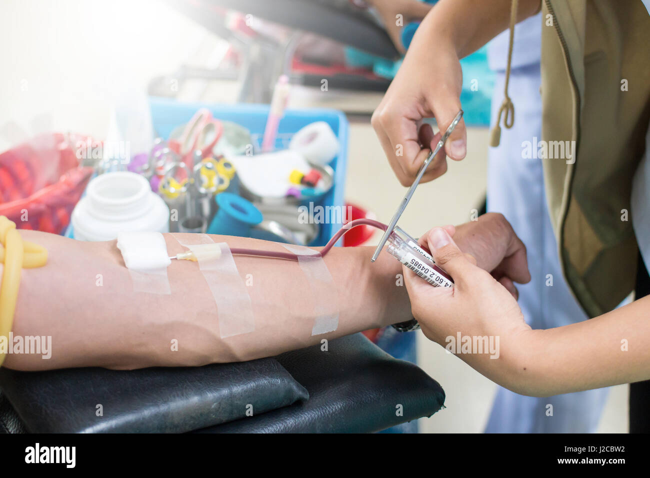 Donate blood using a needle in the arm Stock Photo - Alamy