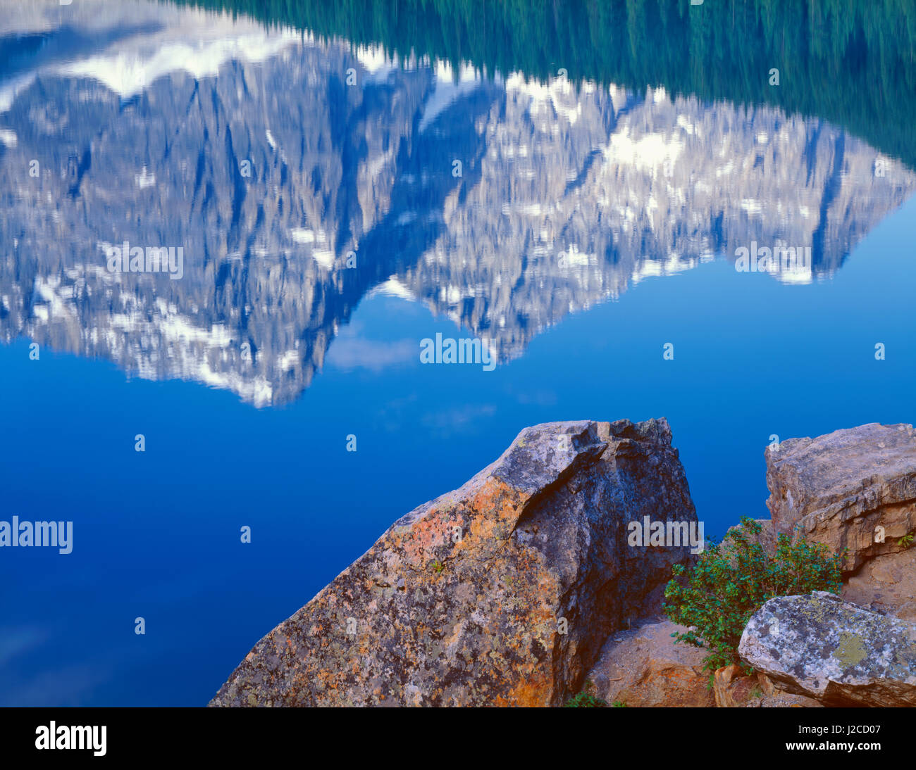 Canada, Alberta, Banff National Park, Lichen covered shoreline rocks ...