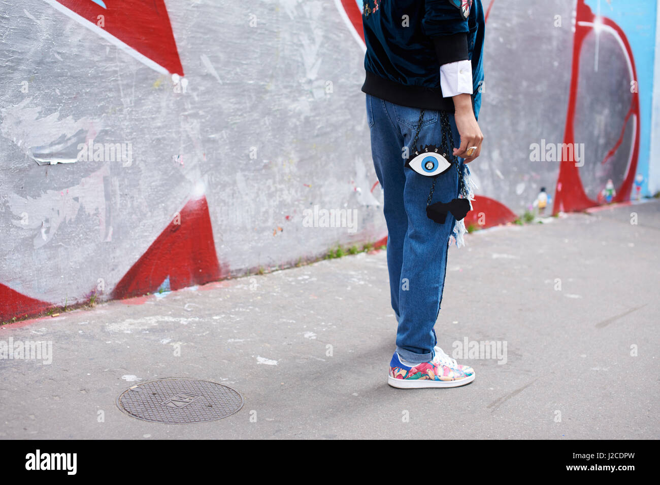 Woman wearing blue jeans and a small shoulder bag, back view Stock ...
