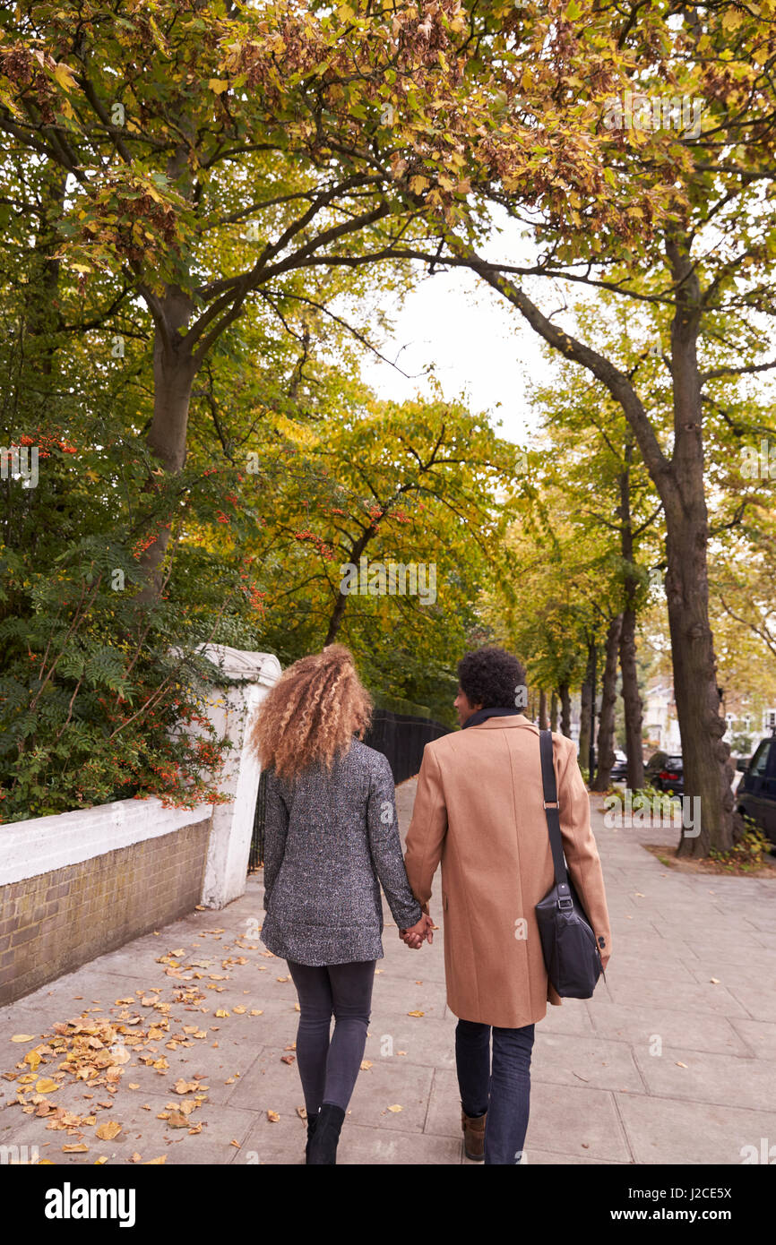 Rear View Of Romantic Couple Walking On Fall Street In City Stock Photo ...