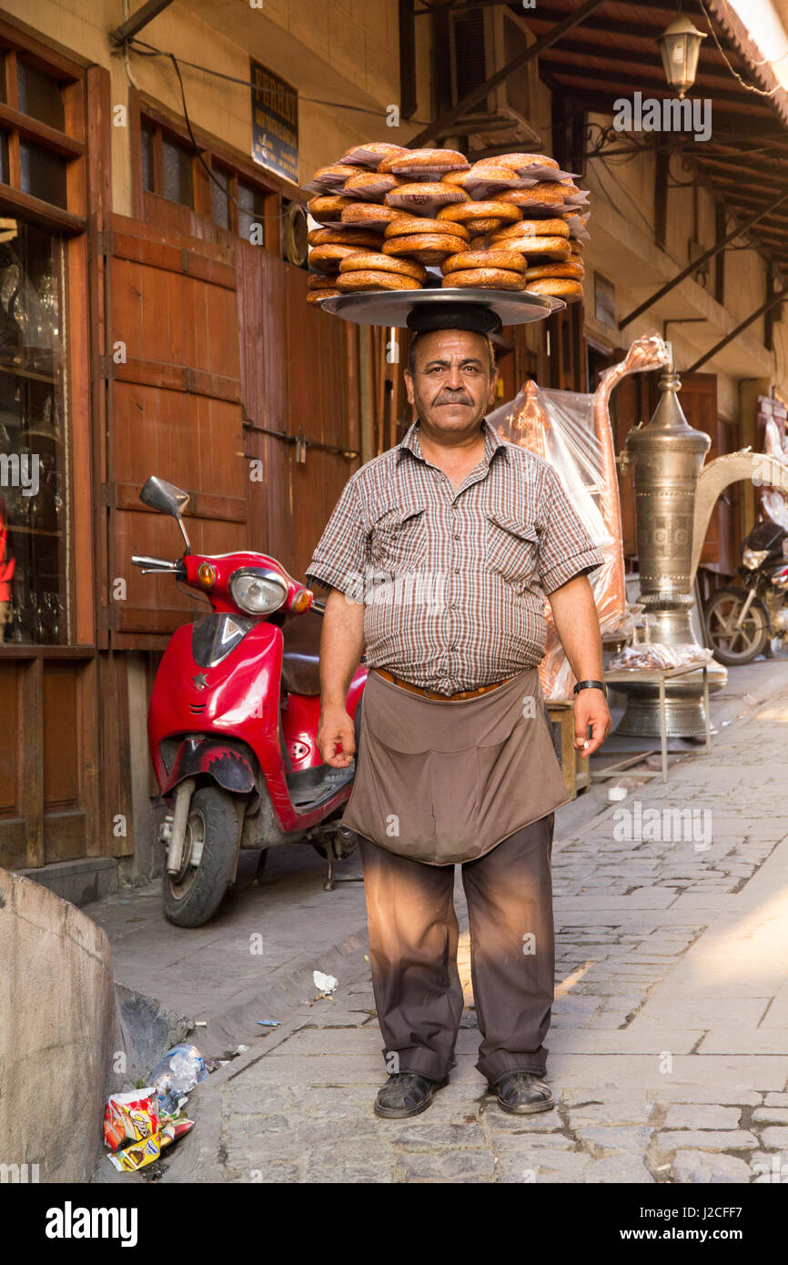 Turkey, Gaziantep. Turkish baker, from Simit bakery. Selling, carrying ...