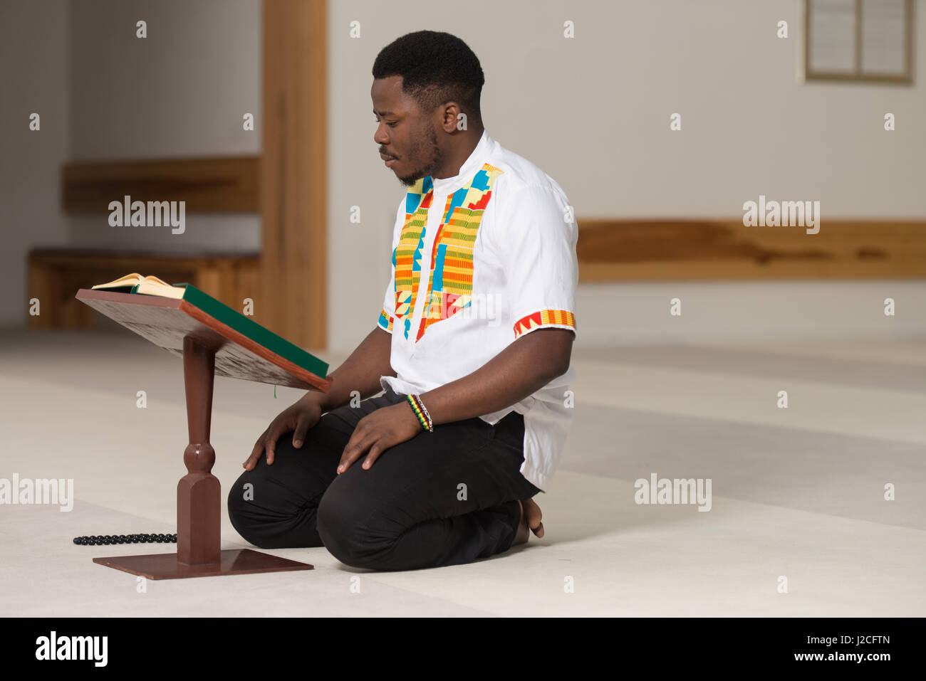 Black African Muslim Man Is Reading The Koran Stock Photo - Alamy