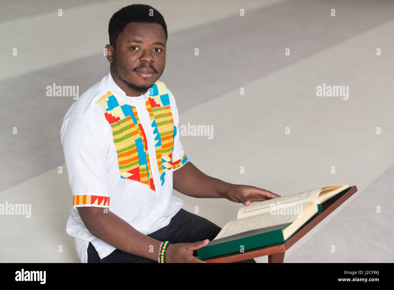 Black African Muslim Man Is Reading The Koran Stock Photo - Alamy
