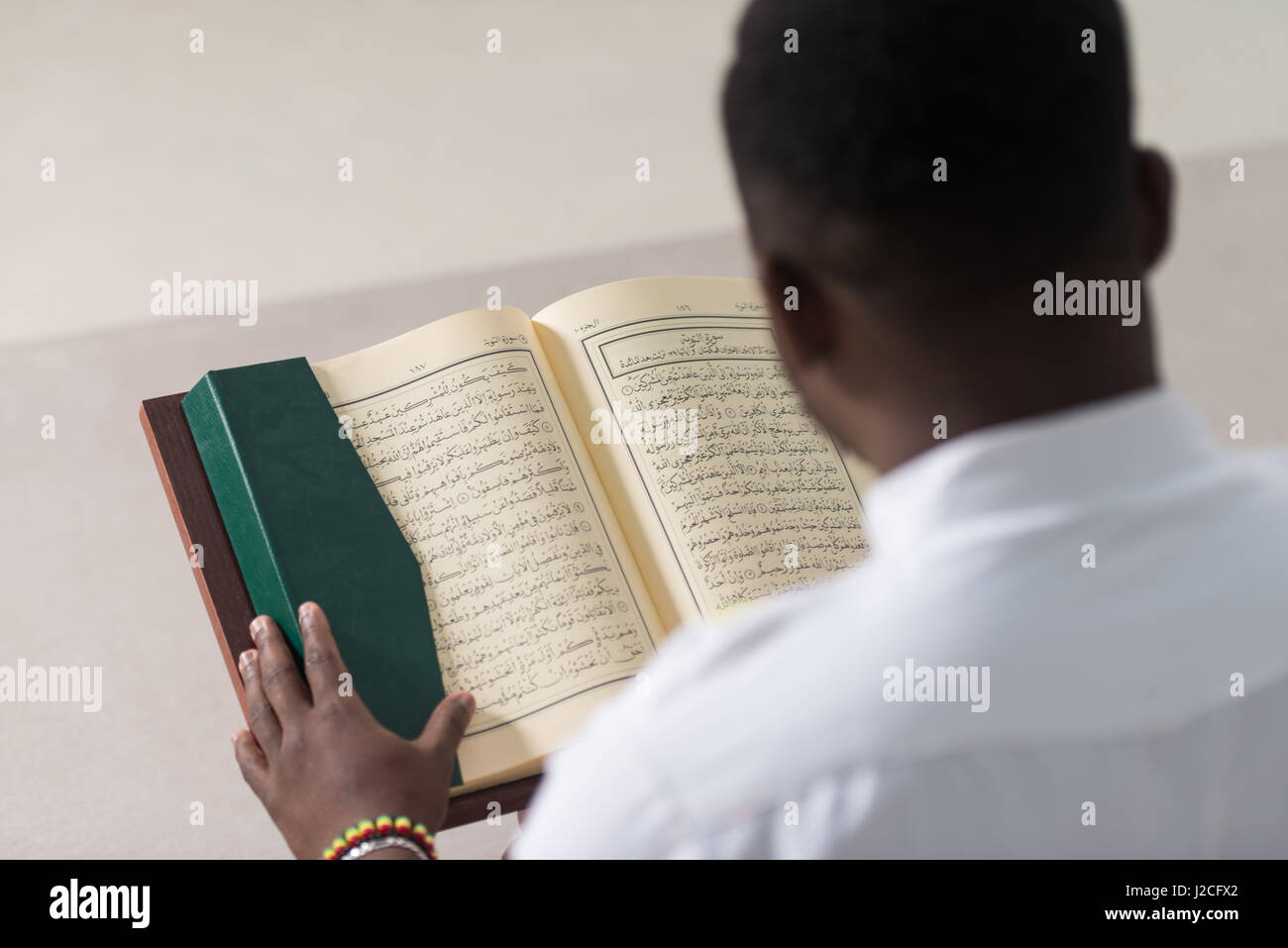 Black African Muslim Man Is Reading The Koran Stock Photo - Alamy