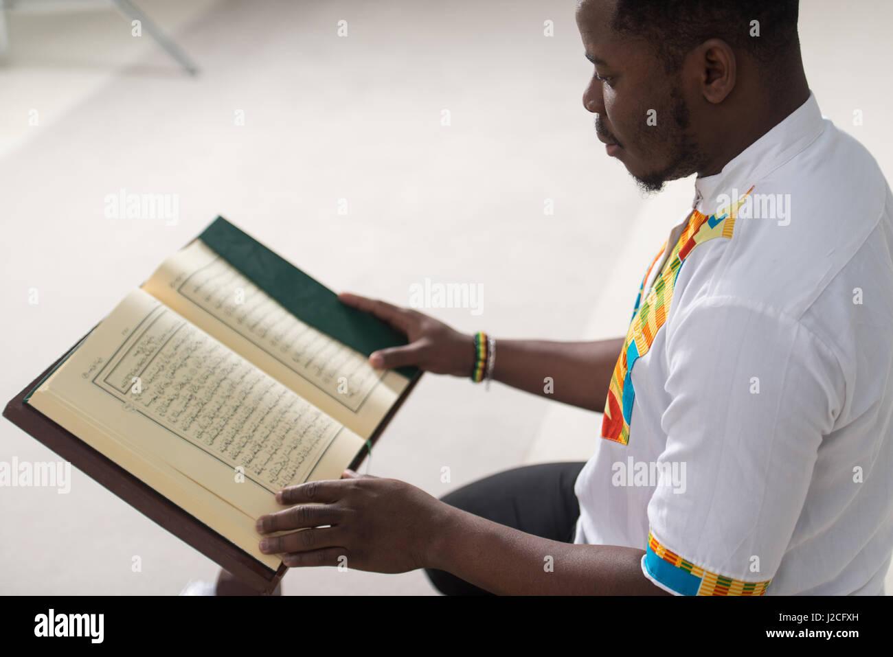Black African Muslim Man Is Reading The Koran Stock Photo - Alamy