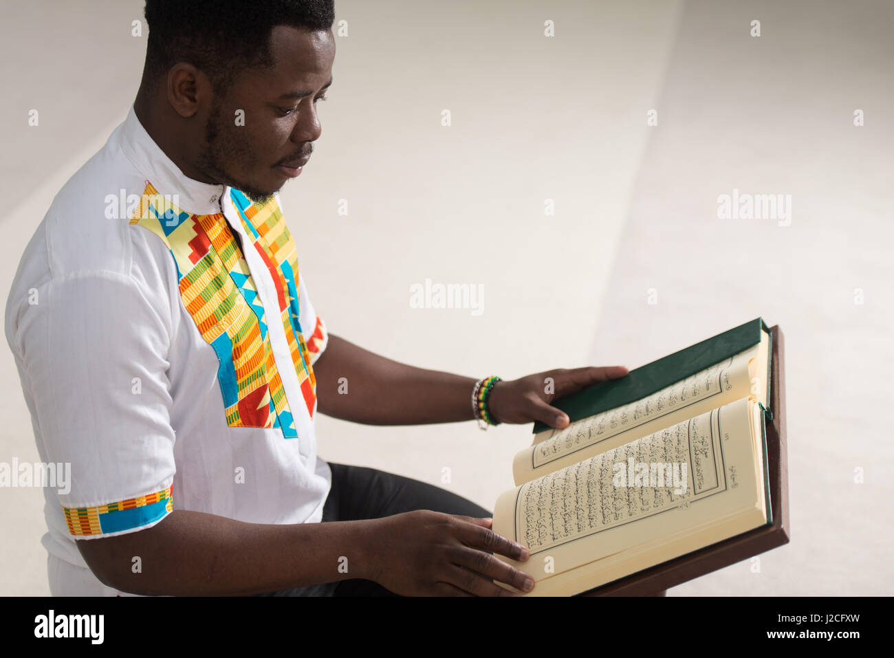 Black African Muslim Man Is Reading The Koran Stock Photo - Alamy