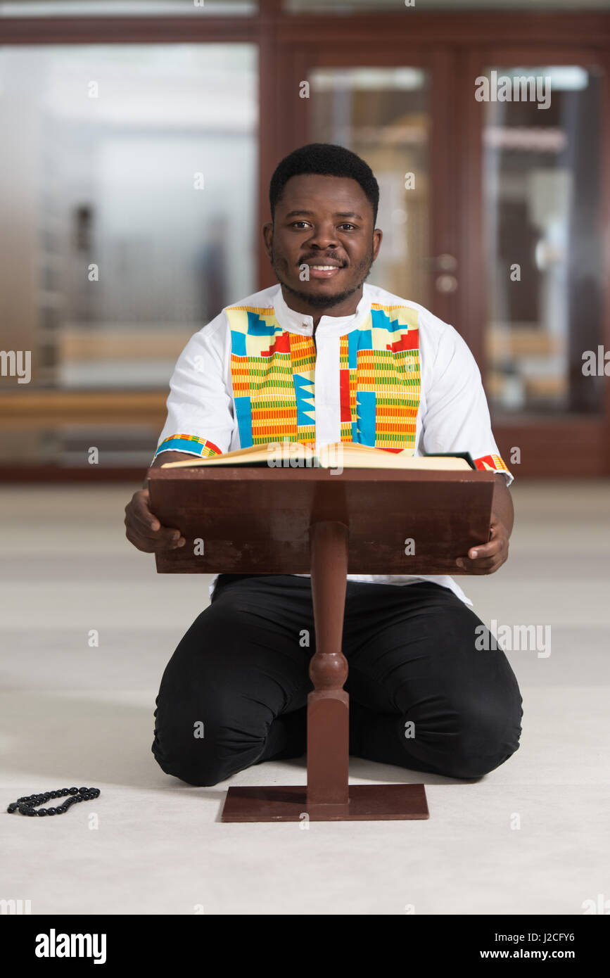 Black African Muslim Man Is Reading The Koran Stock Photo - Alamy