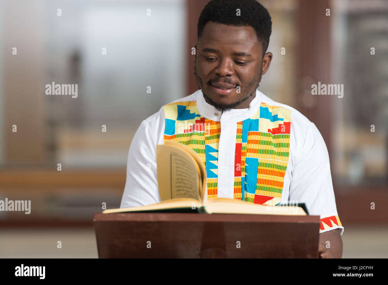 Black African Muslim Man Is Reading The Koran Stock Photo - Alamy