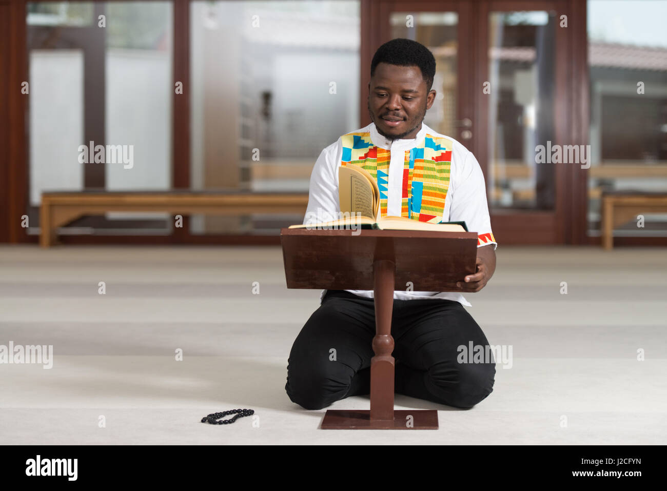 Black African Muslim Man Is Reading The Koran Stock Photo - Alamy