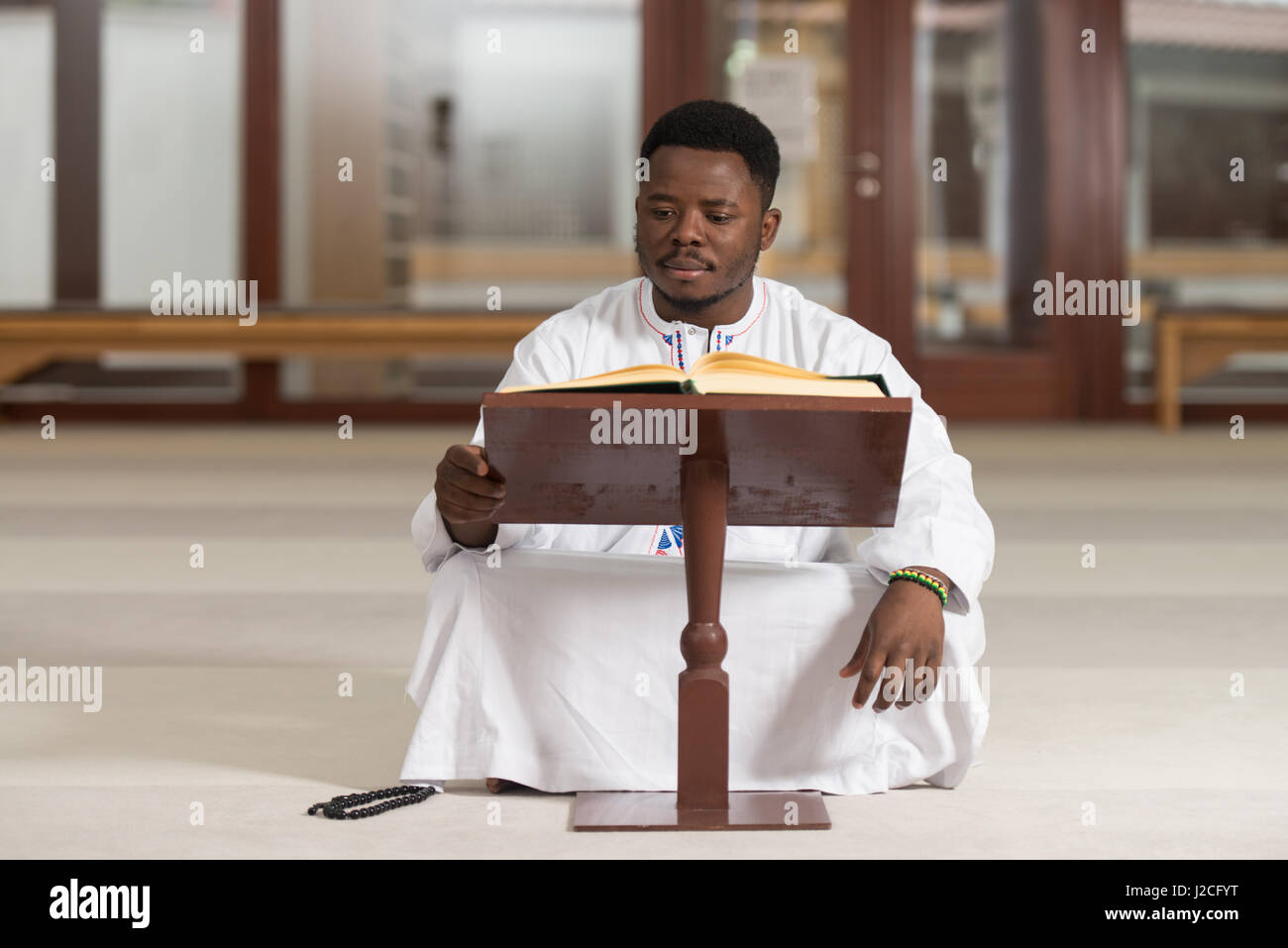 Black African Muslim Man Reading Holy Islamic Book Koran Stock Photo ...