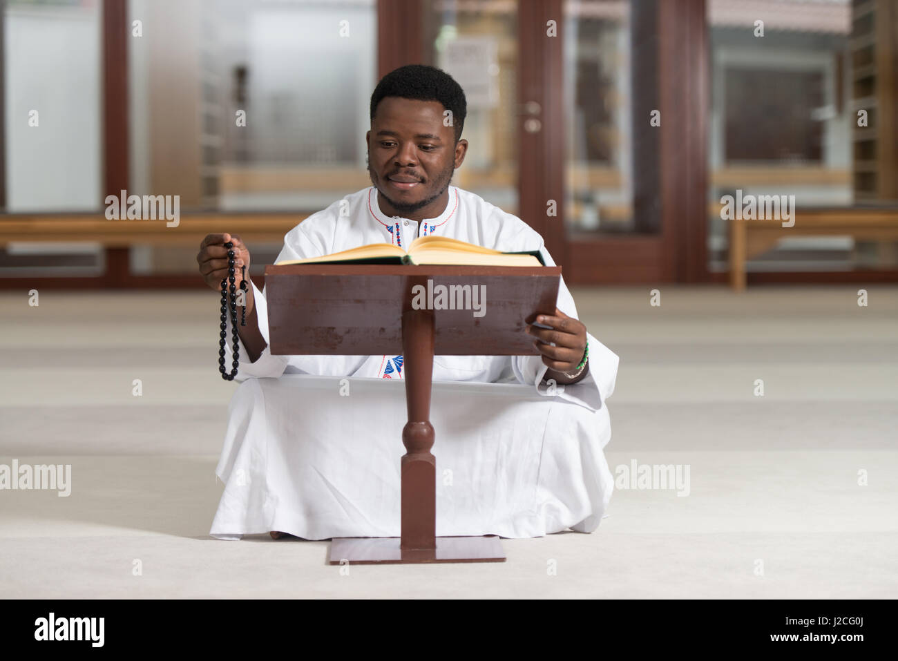 Black African Muslim Man Reading Holy Islamic Book Koran Stock Photo ...