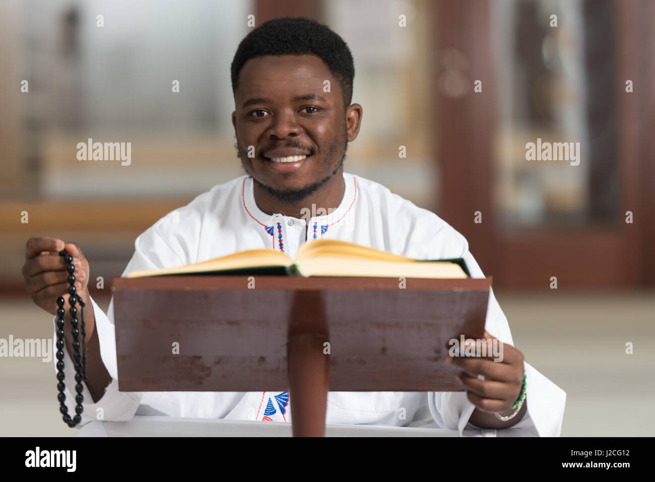 Black African Muslim Man Reading Holy Islamic Book Koran Stock Photo ...