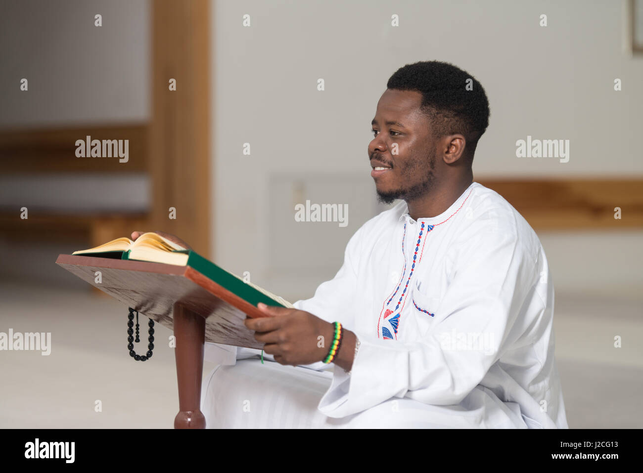 Black African Muslim Man Reading Holy Islamic Book Koran Stock Photo ...