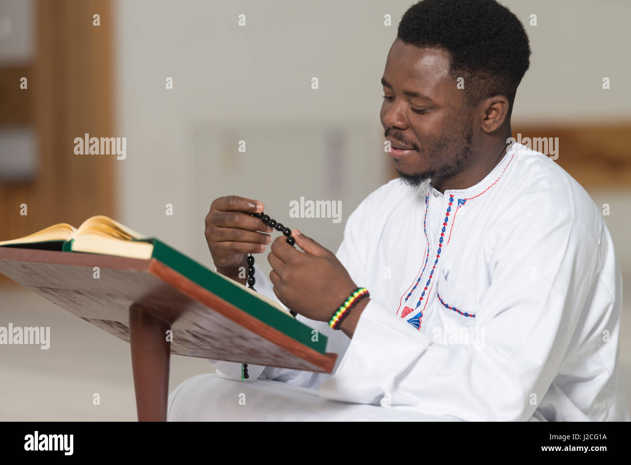 Black African Muslim Man Reading Holy Islamic Book Koran Stock Photo ...