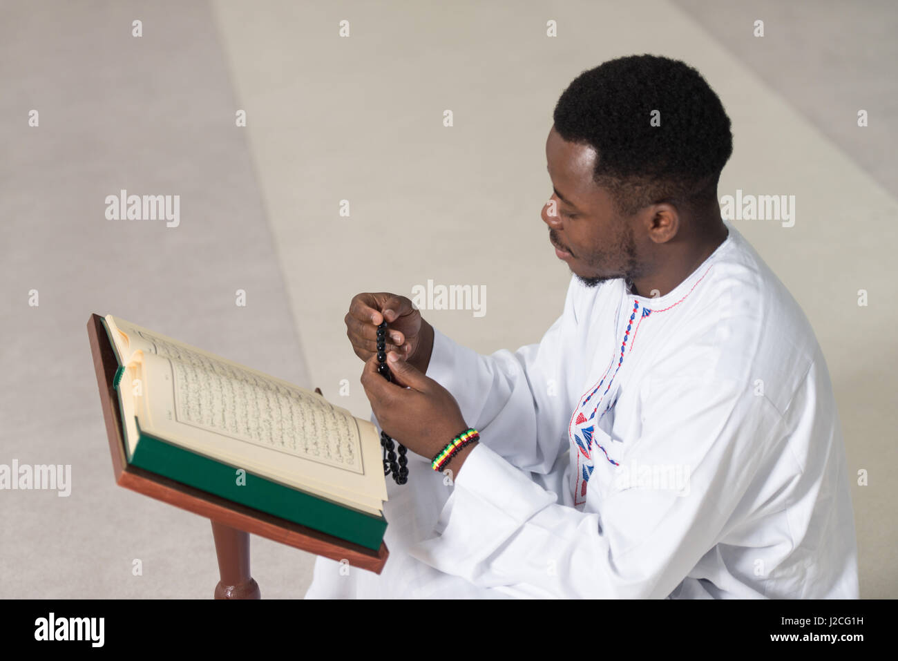 Black African Muslim Man Reading Holy Islamic Book Koran Stock Photo ...