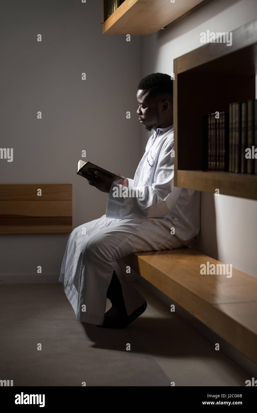 Black African Muslim Man Reading Holy Islamic Book Koran Stock Photo ...