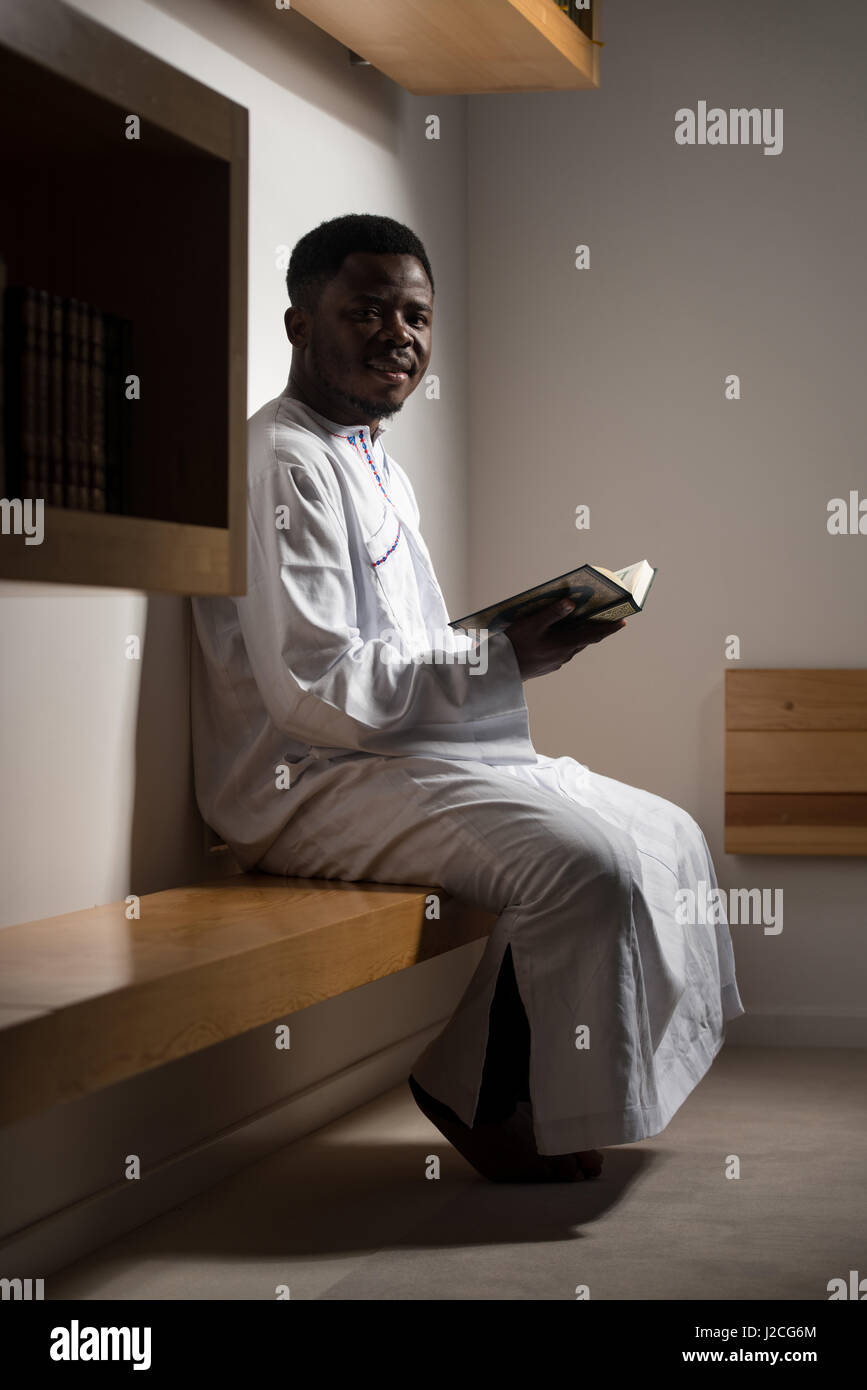 Black African Muslim Man Reading Holy Islamic Book Koran Stock Photo ...